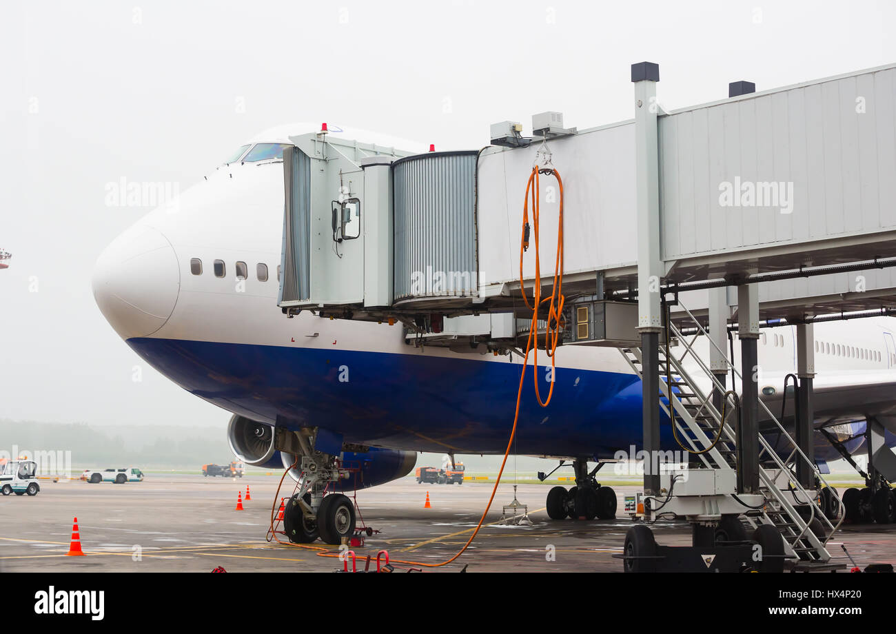 The plane at the airport loading passengers Stock Photo - Alamy