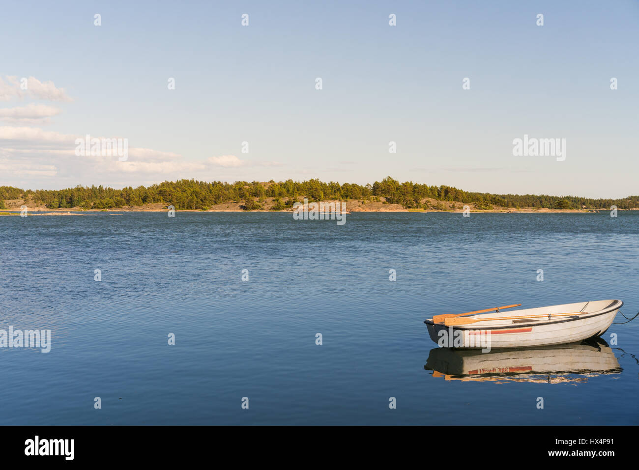 A ROWING BOAT FLOATS IN THE FINNISH SWEDISH archipelago IN THE BALTIC ...