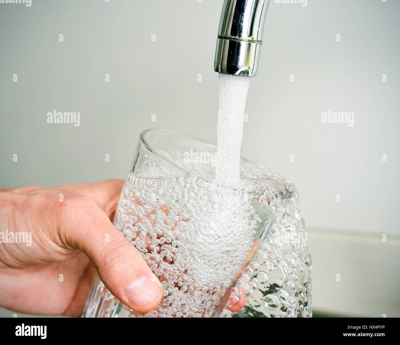 closeup of a young caucasian man filling a glass of tap water Stock ...