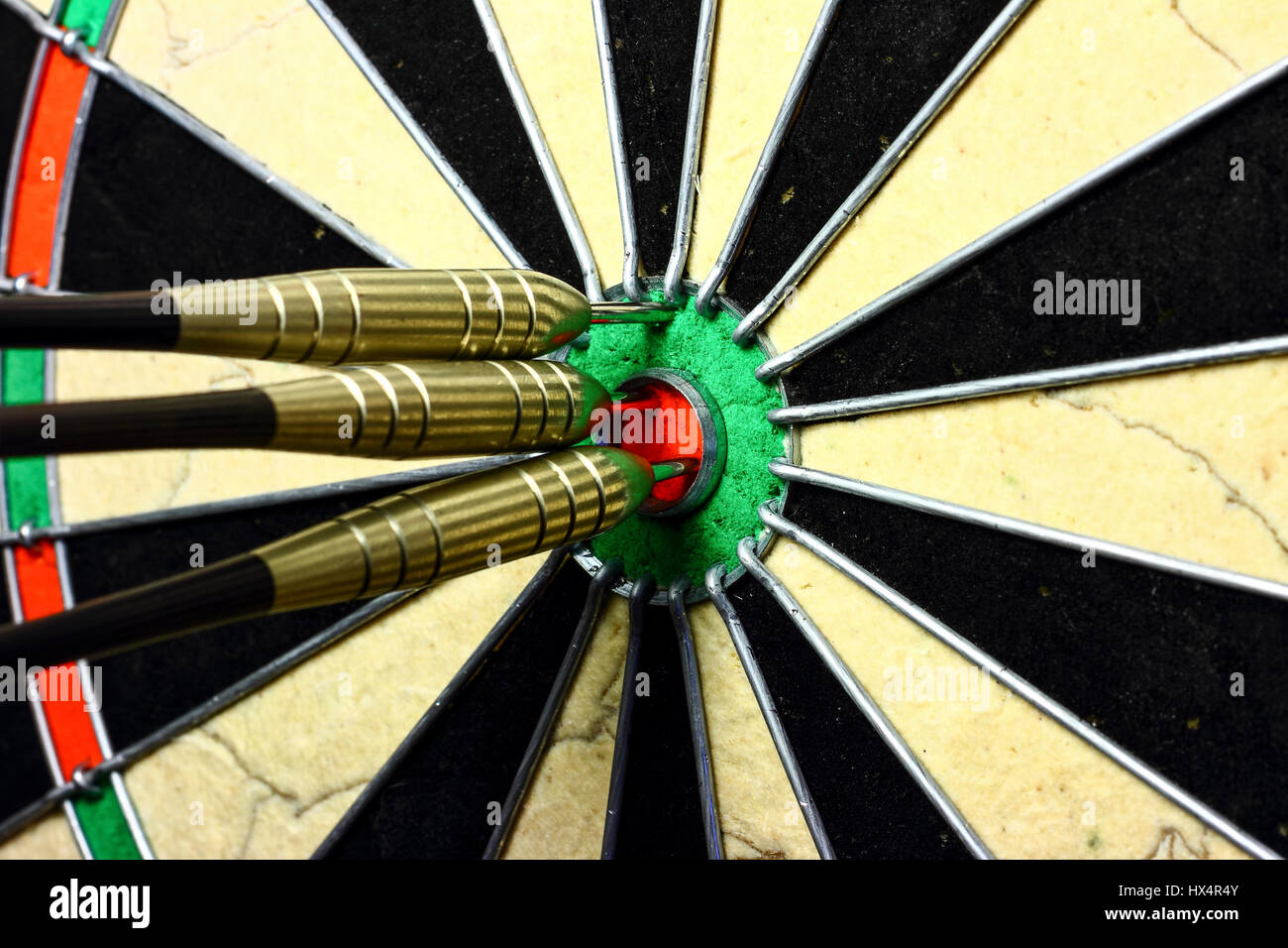 Dart board with darts grouped together around the bulls eye Stock Photo ...