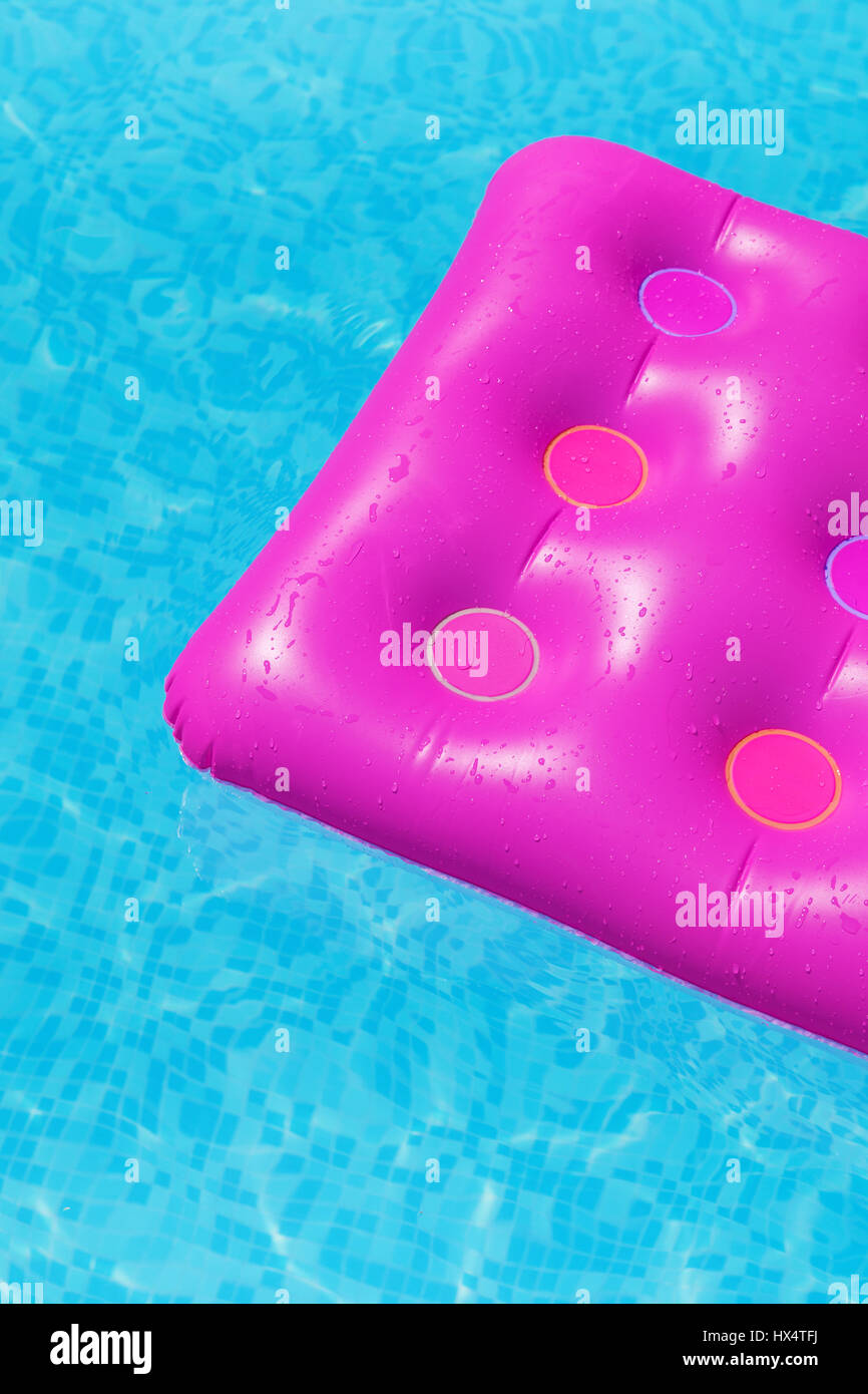 Pink air mattress on a swimming pool - holiday tropical background ...