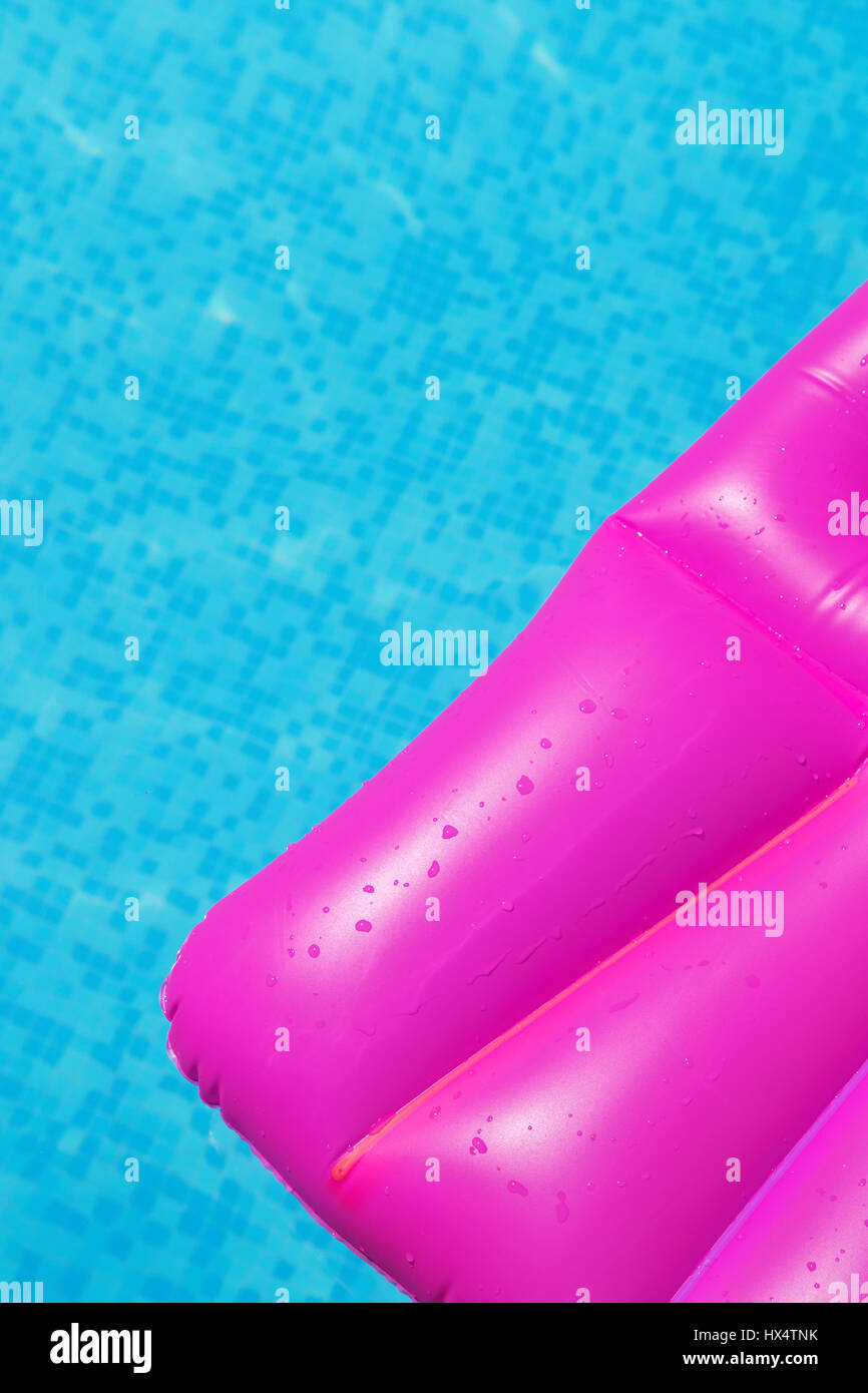 Pink air mattress on a swimming pool - holiday tropical background ...