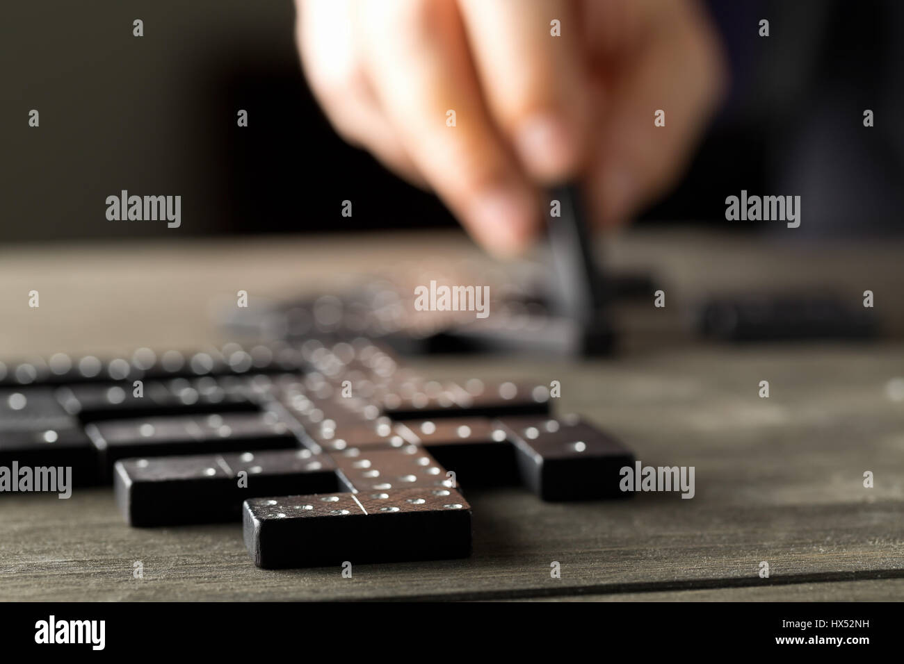 Game of domino with domino stones on wooden background with man about ...