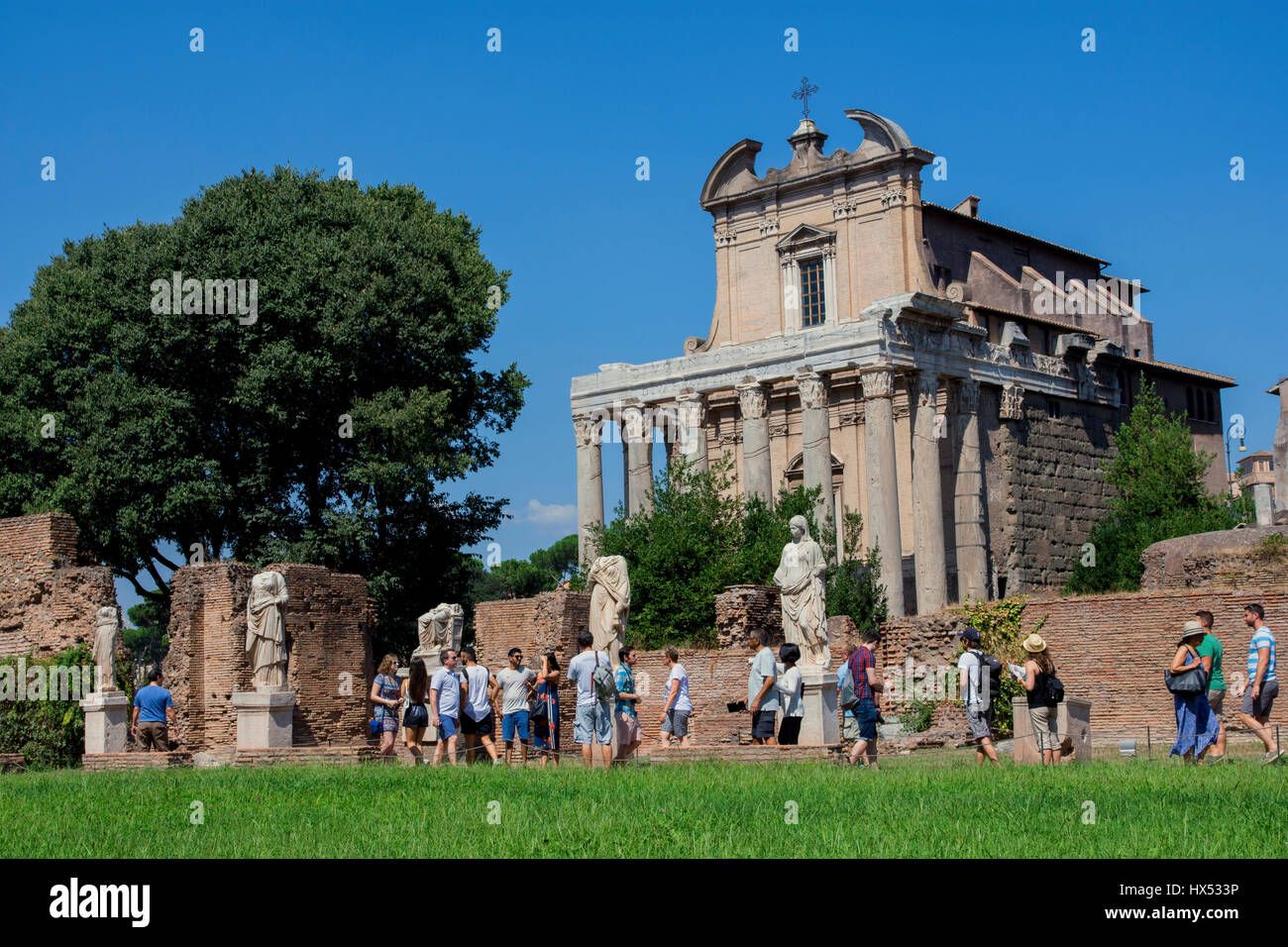 Tourists visit House of the Vestal ruins and Temple of Antoninus and ...