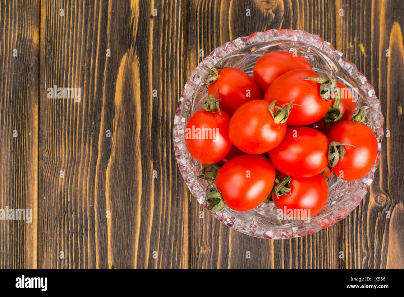 Small red tomatoes in crystal bowl. Studio Photo Stock Photo - Alamy