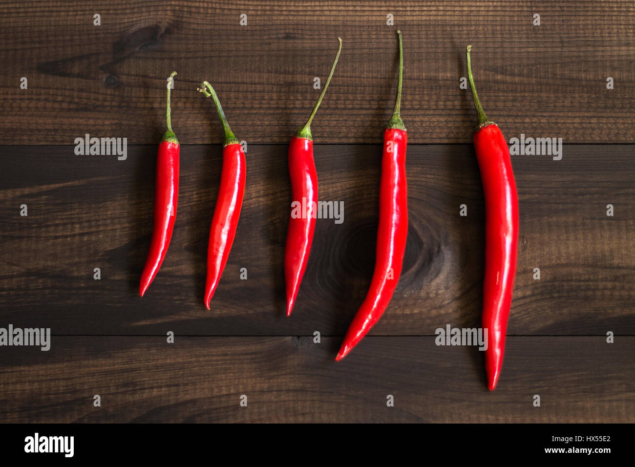 cayenne chilli peppers on wooden background Stock Photo - Alamy