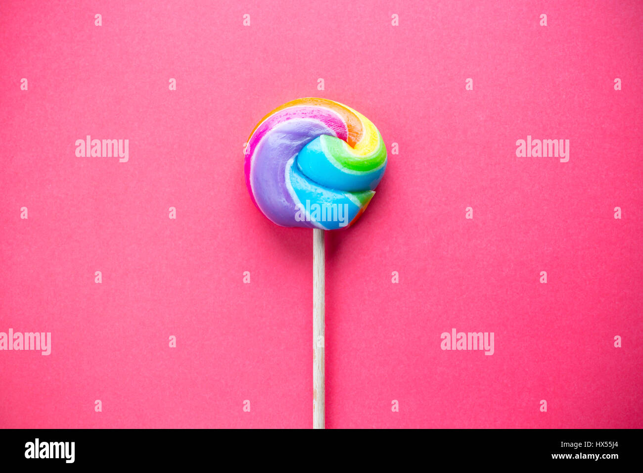 rainbow colored lollipop isolated on pink background. copy space Stock ...