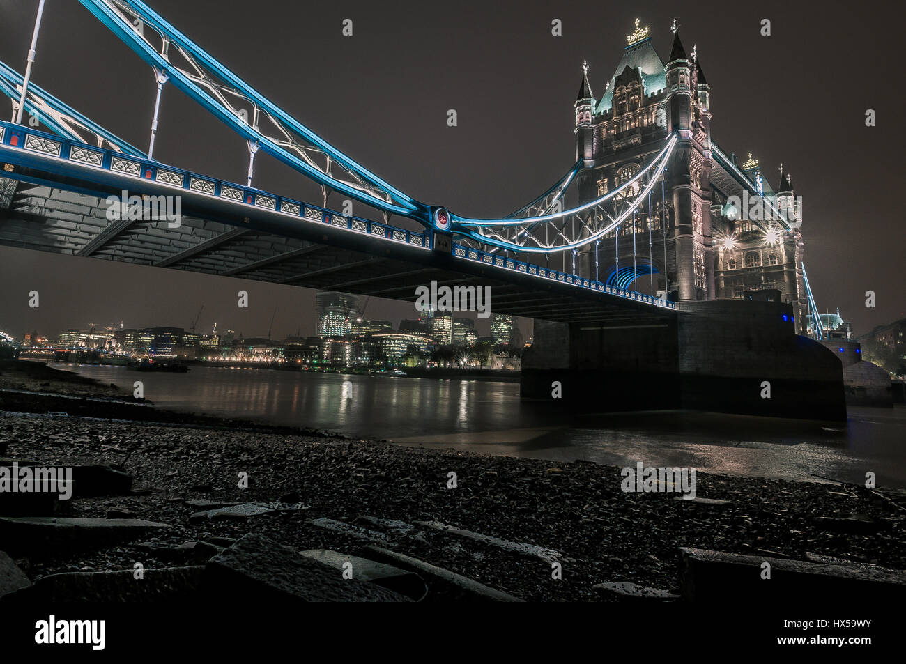 Below Tower Bridge at night lit up Stock Photo - Alamy