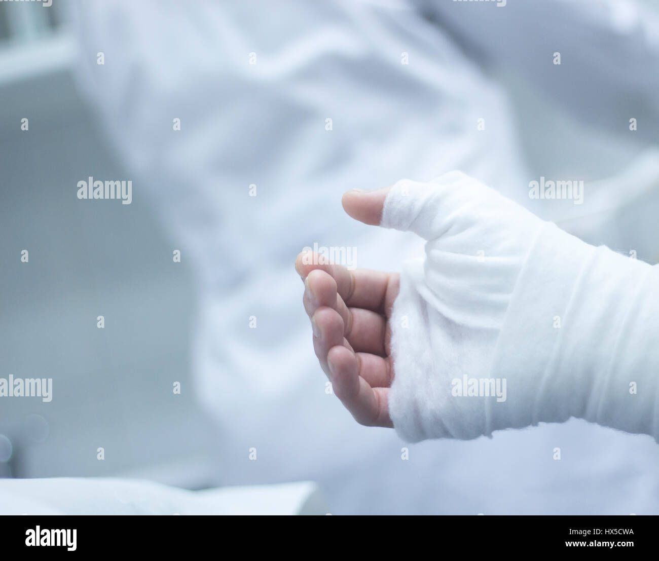 Doctor applying a plaster cast and bandages to patient forearm and ...