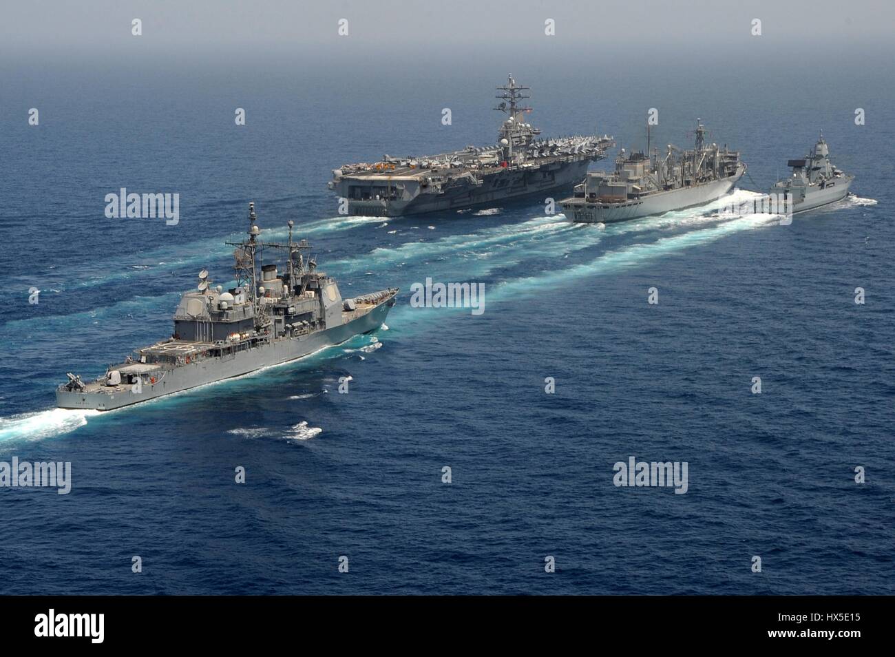 Guided-missile cruiser USS Hue City (CG 66) astern of the German navy ...