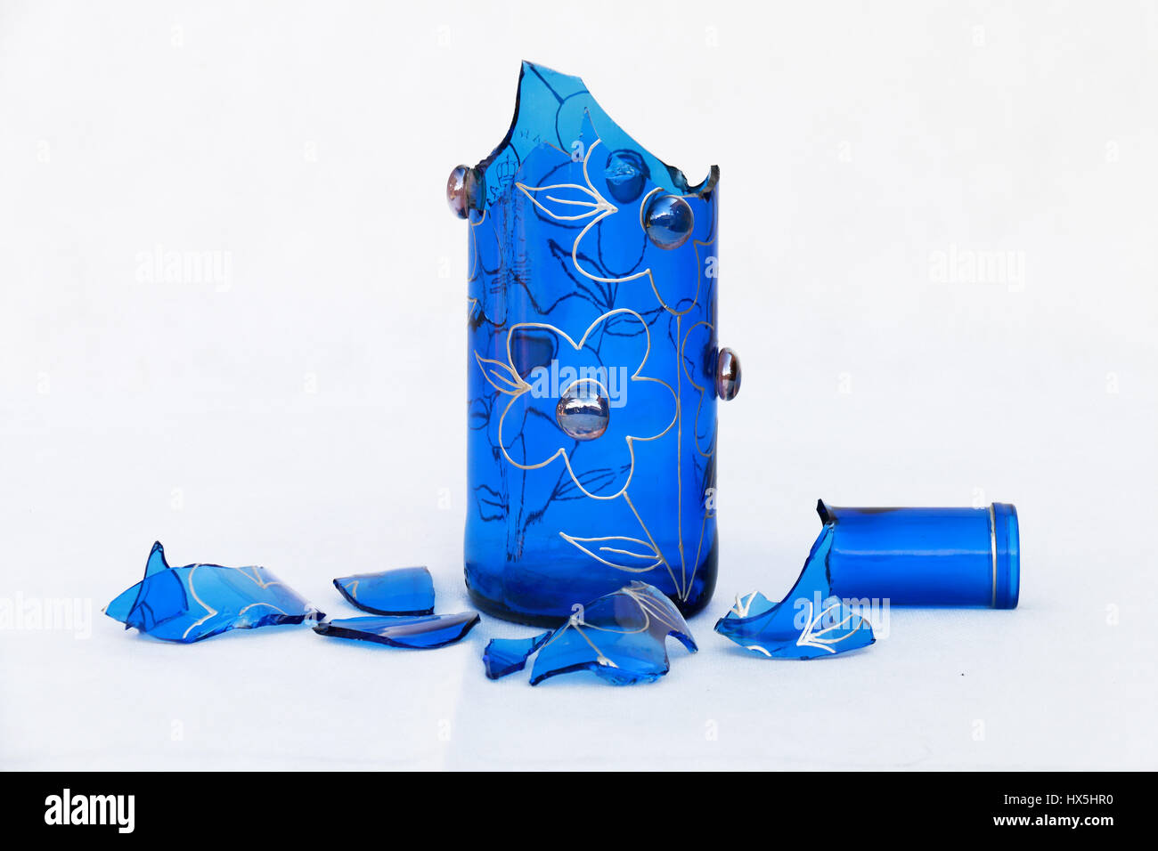 Broken glass blue bottle, centered image isolated on white background ...