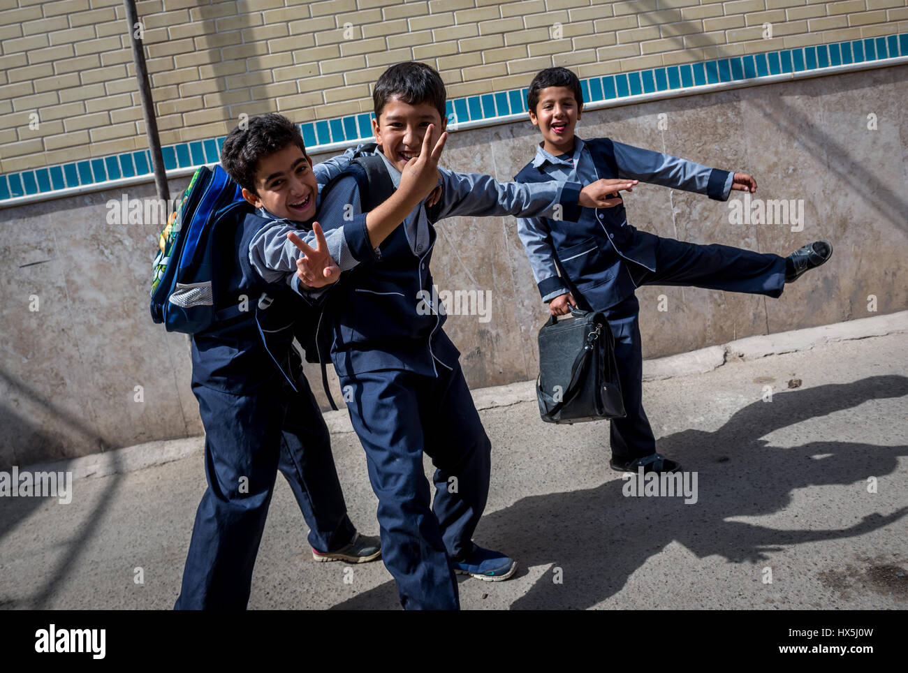 Iranian schoolboys acting on street in Kashan city, capital of Kashan ...