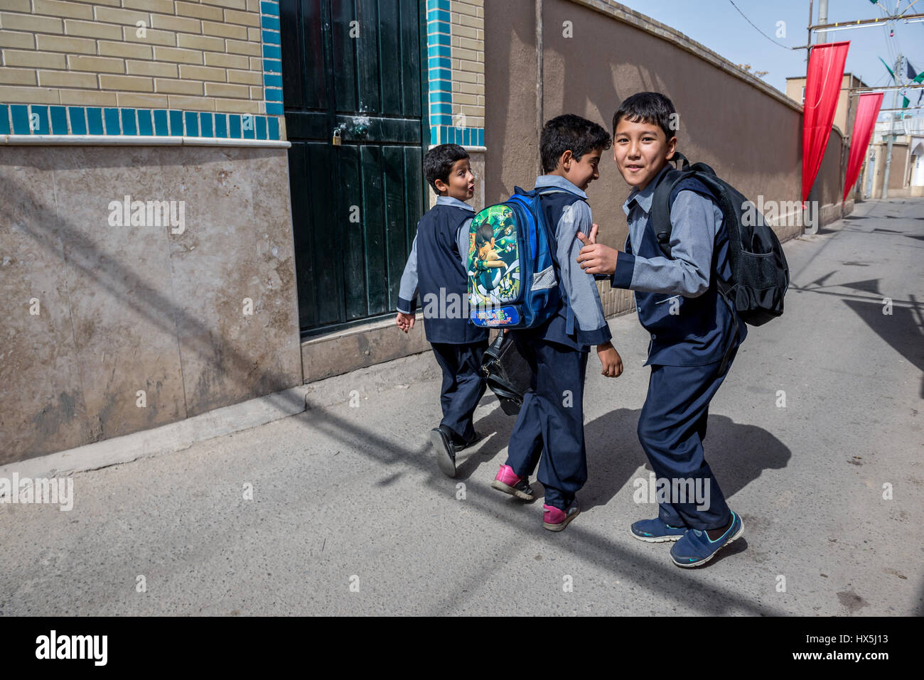 Iranian schoolboys acting on street in Kashan city, capital of Kashan ...