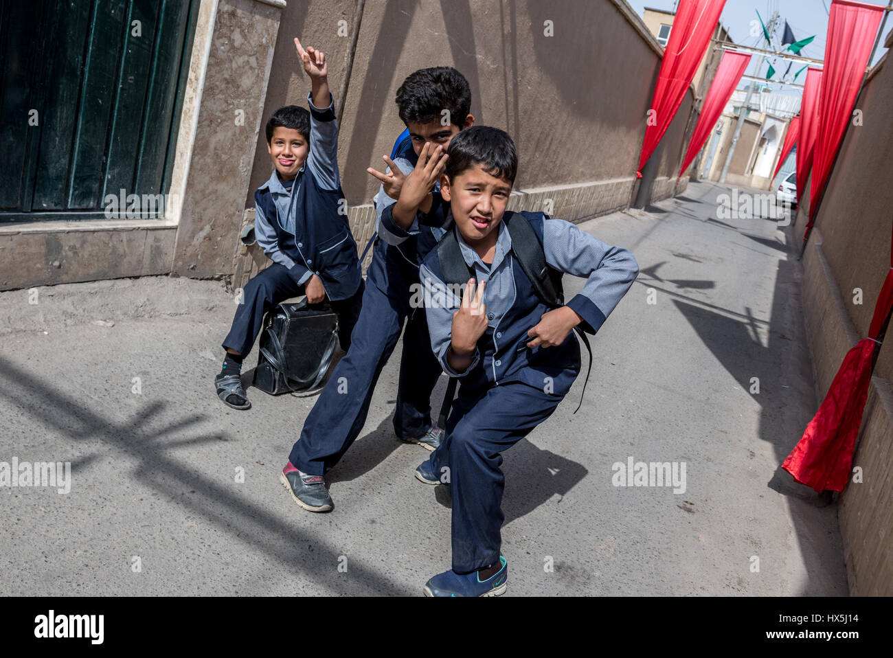 Iranian schoolboys acting on street in Kashan city, capital of Kashan ...