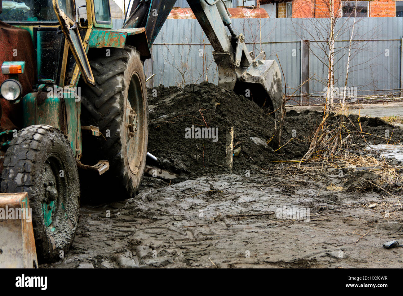 An old Soviet tractor digs and loads waste stone processing near the ...