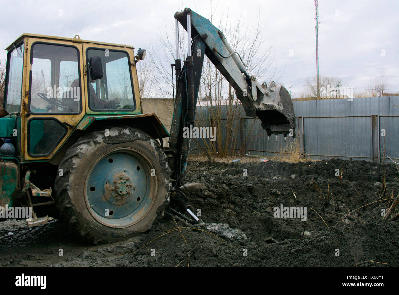 An old Soviet tractor digs and loads waste stone processing near the ...