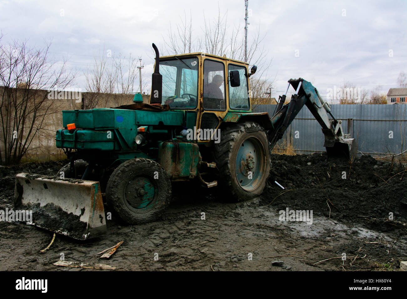 An old Soviet tractor digs and loads waste stone processing near the ...