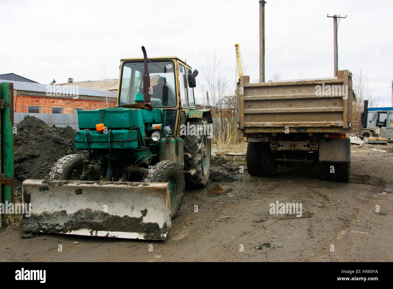 An old Soviet tractor digs and loads waste stone processing near the ...