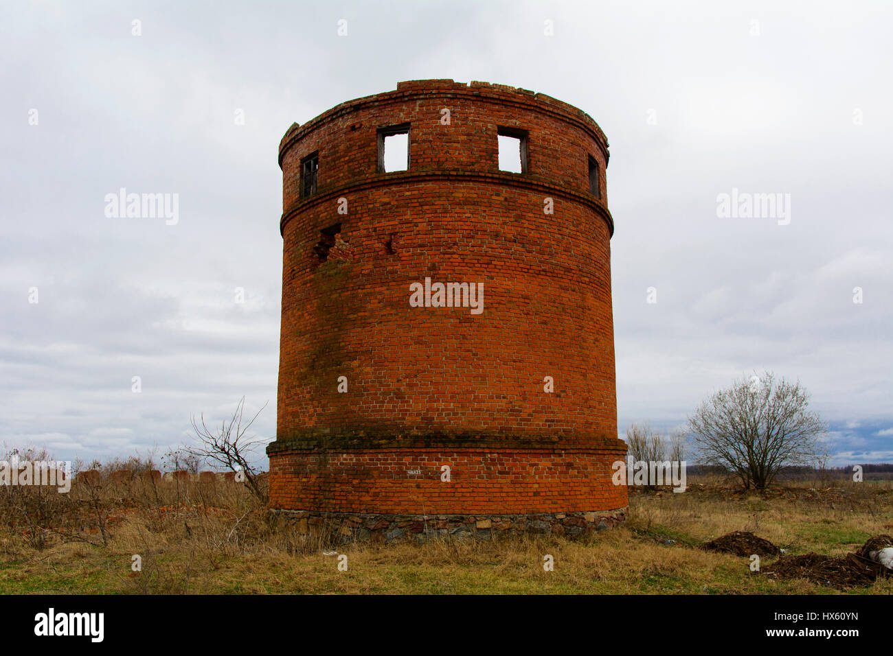The old destroyed water tower standing alone in the field Stock Photo ...
