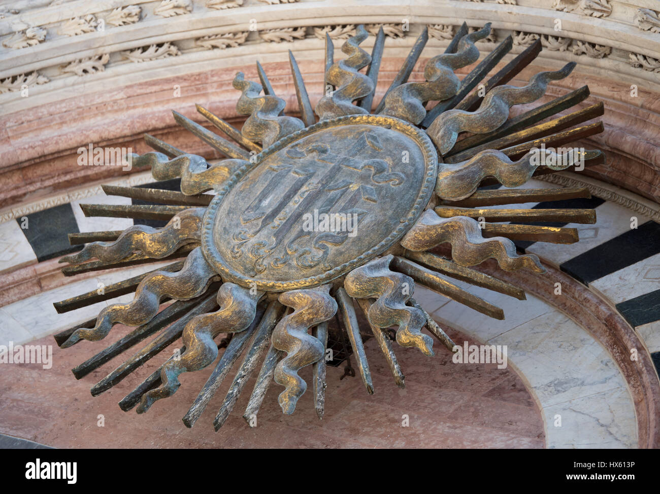 Solar disc above the central portal of the main facade of Siena ...