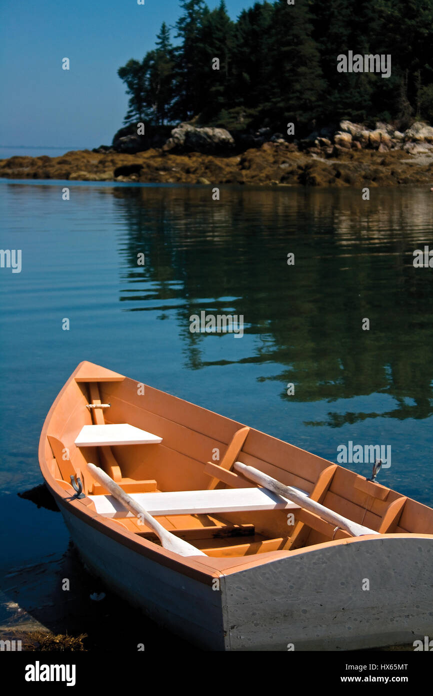A small peach pink and white rowboat on the coast of Maine near Bar ...