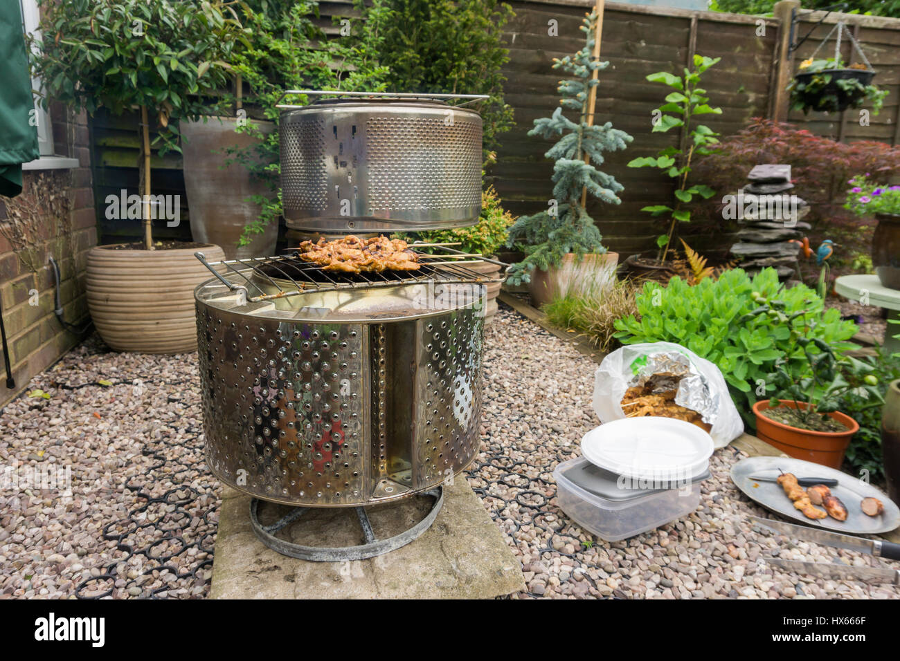 Barbecue in a garden made from a washing machine Stock Photo - Alamy