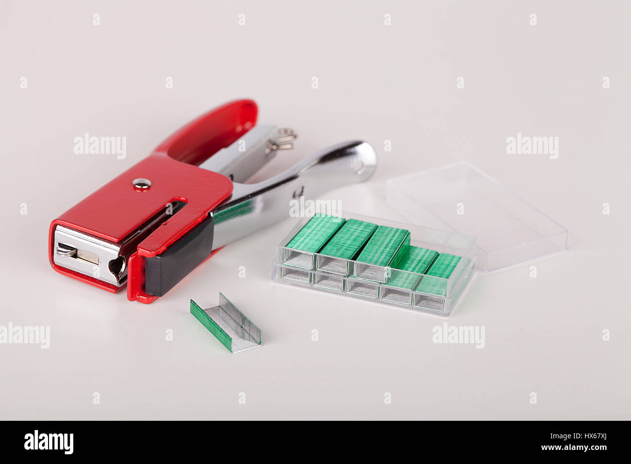 Red stapler and green staples isolated on white background Stock Photo ...