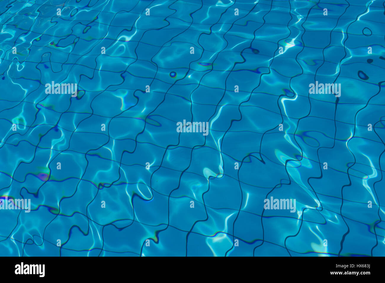 A blue pattern of a swimming pool textured with squared tiles Stock ...