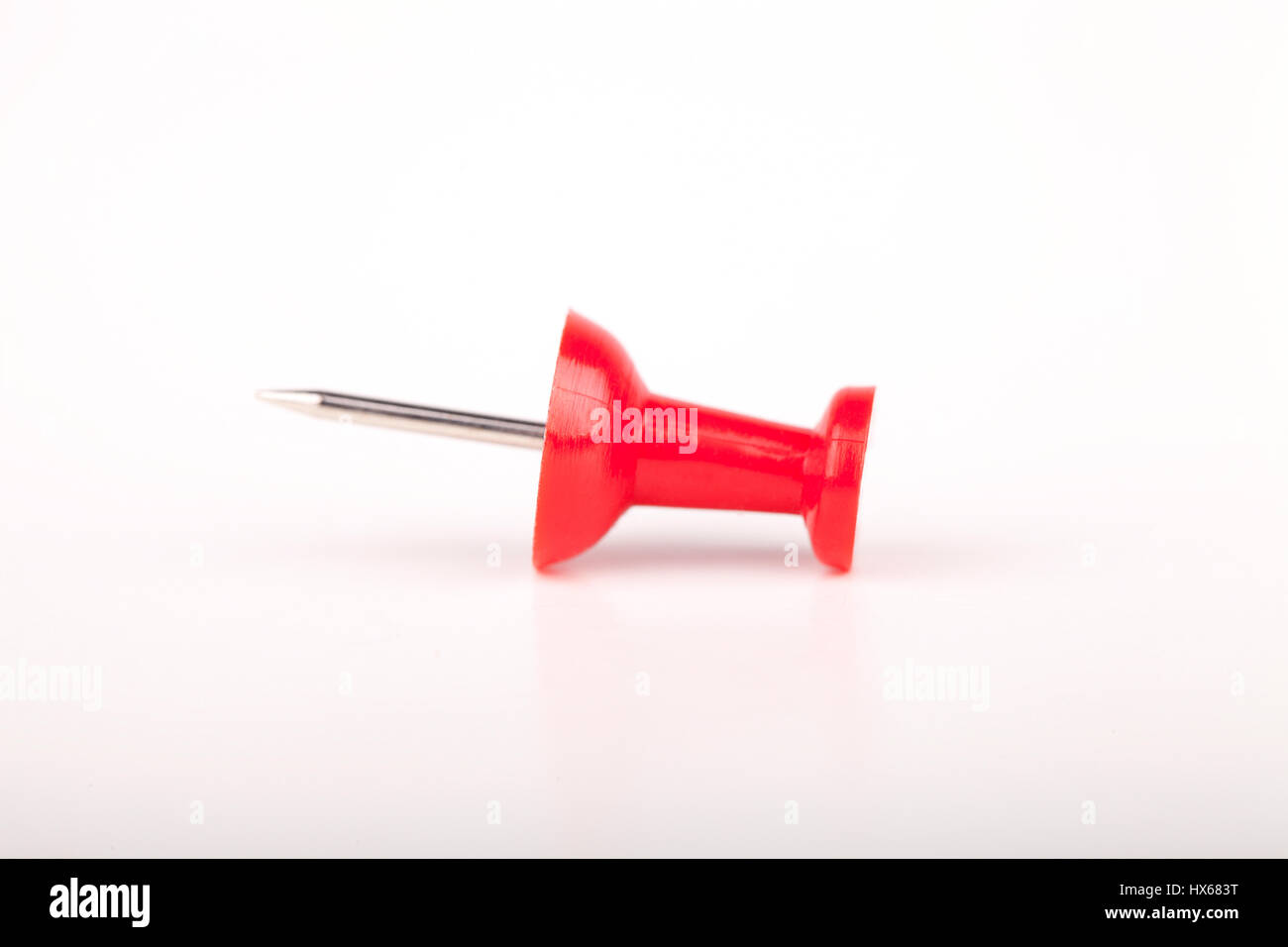 Red pushpin on a white surface. Push pin isolated on white background ...