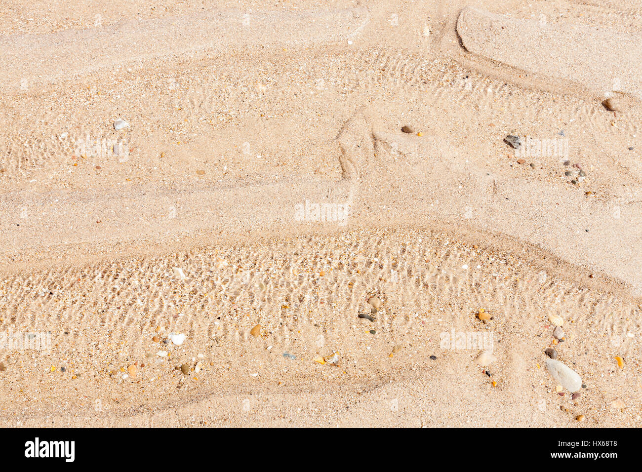 Close up from above of sea water flowing and rippling over sand on a ...