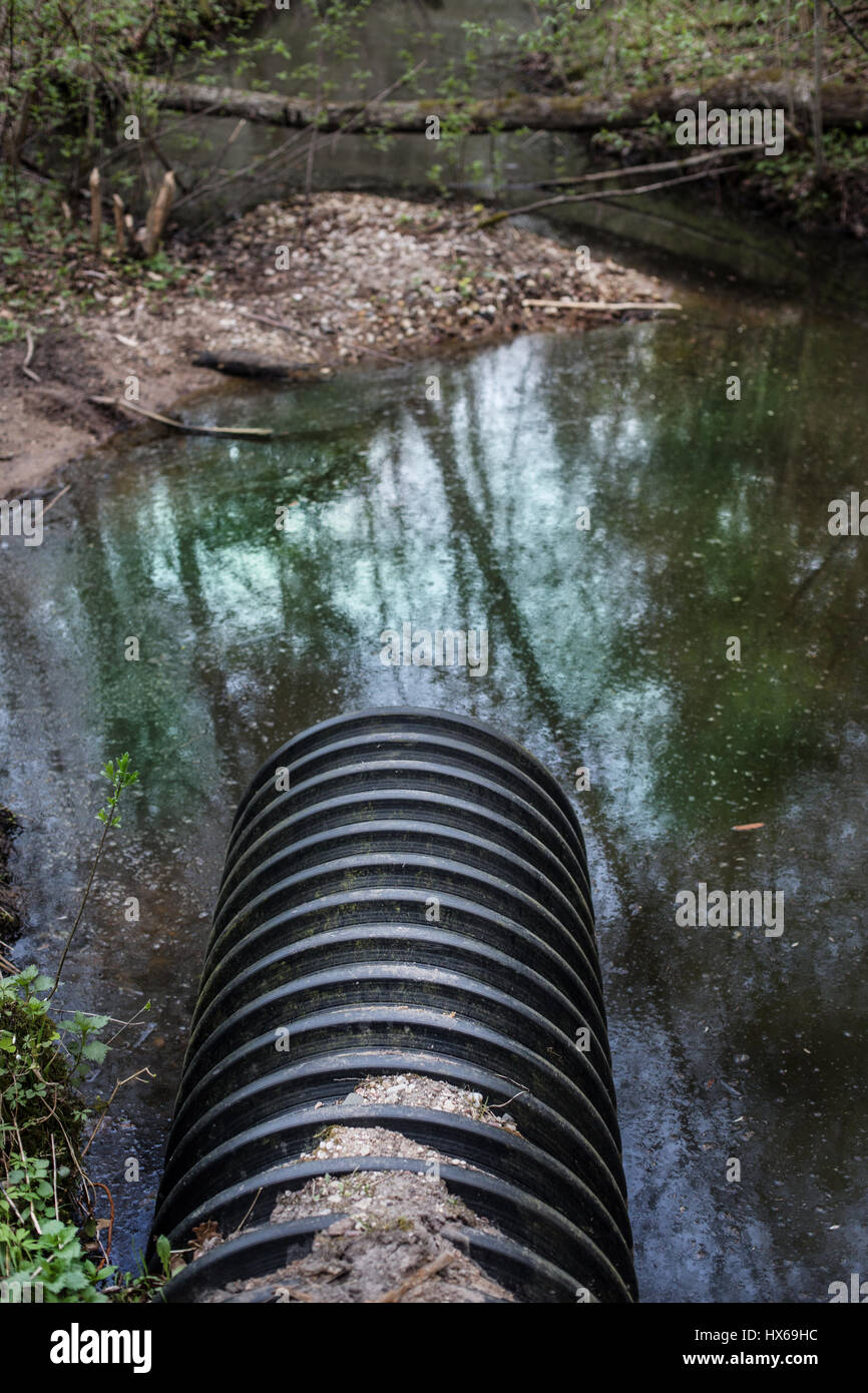 Dirty water stems from the pipe polluting the river Stock Photo - Alamy