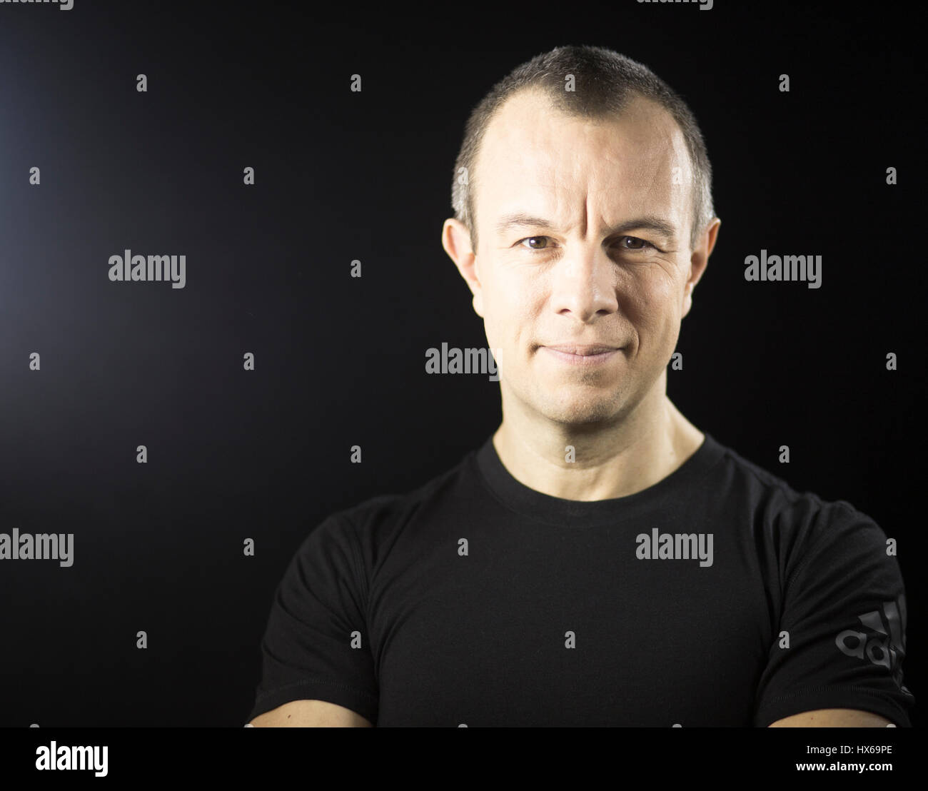 Attractive handsome slim healthy man aged in 40's in black t-shirt ...