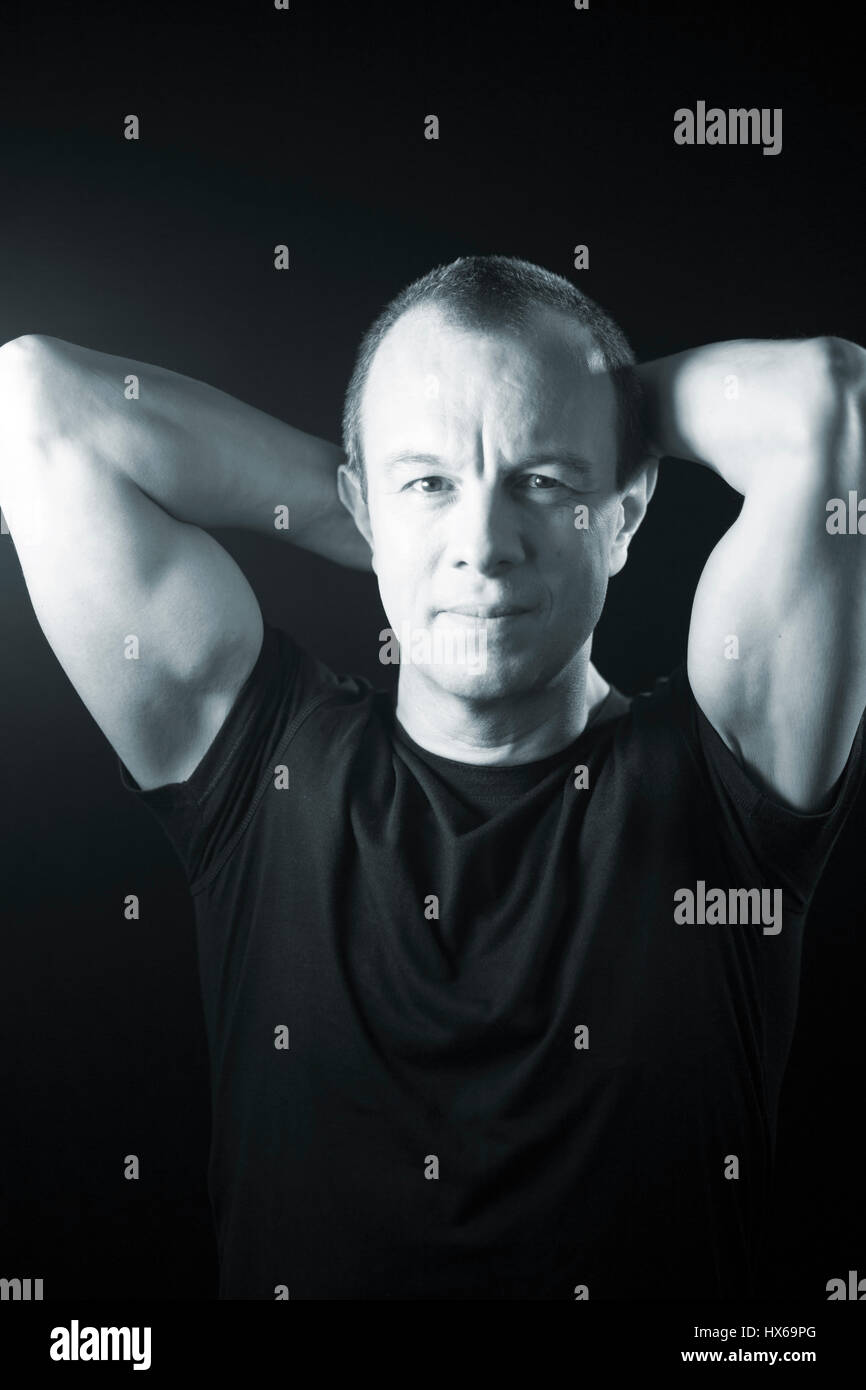 Attractive handsome slim healthy man aged in 40's in black t-shirt ...