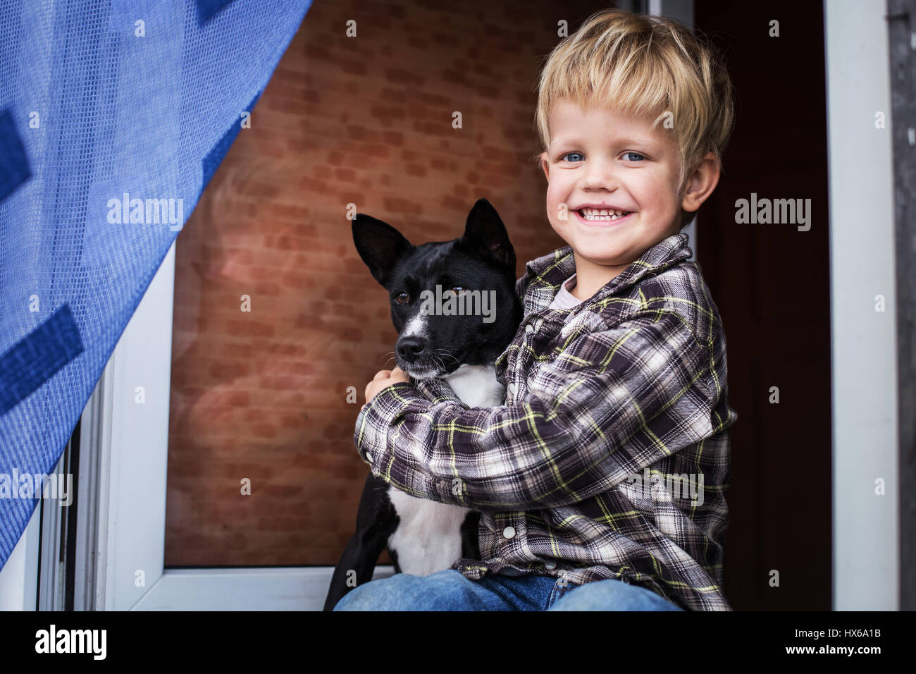 Smiling beautiful blond kid and his dog. Boy and basenji. Outdoor ...