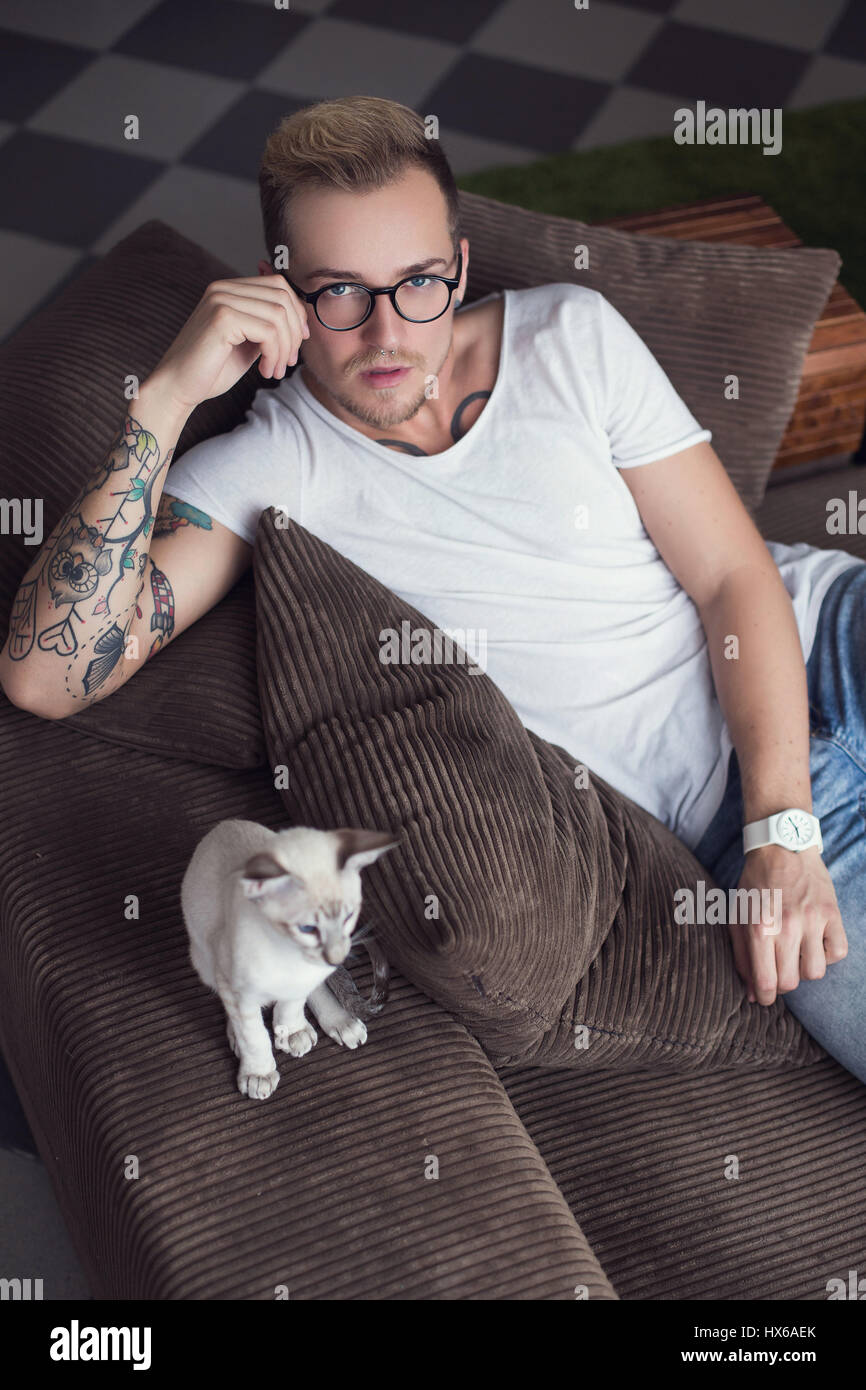 Man and a cat at home. Oriental Shorthair. Pets. Cat. Indoor portrait ...