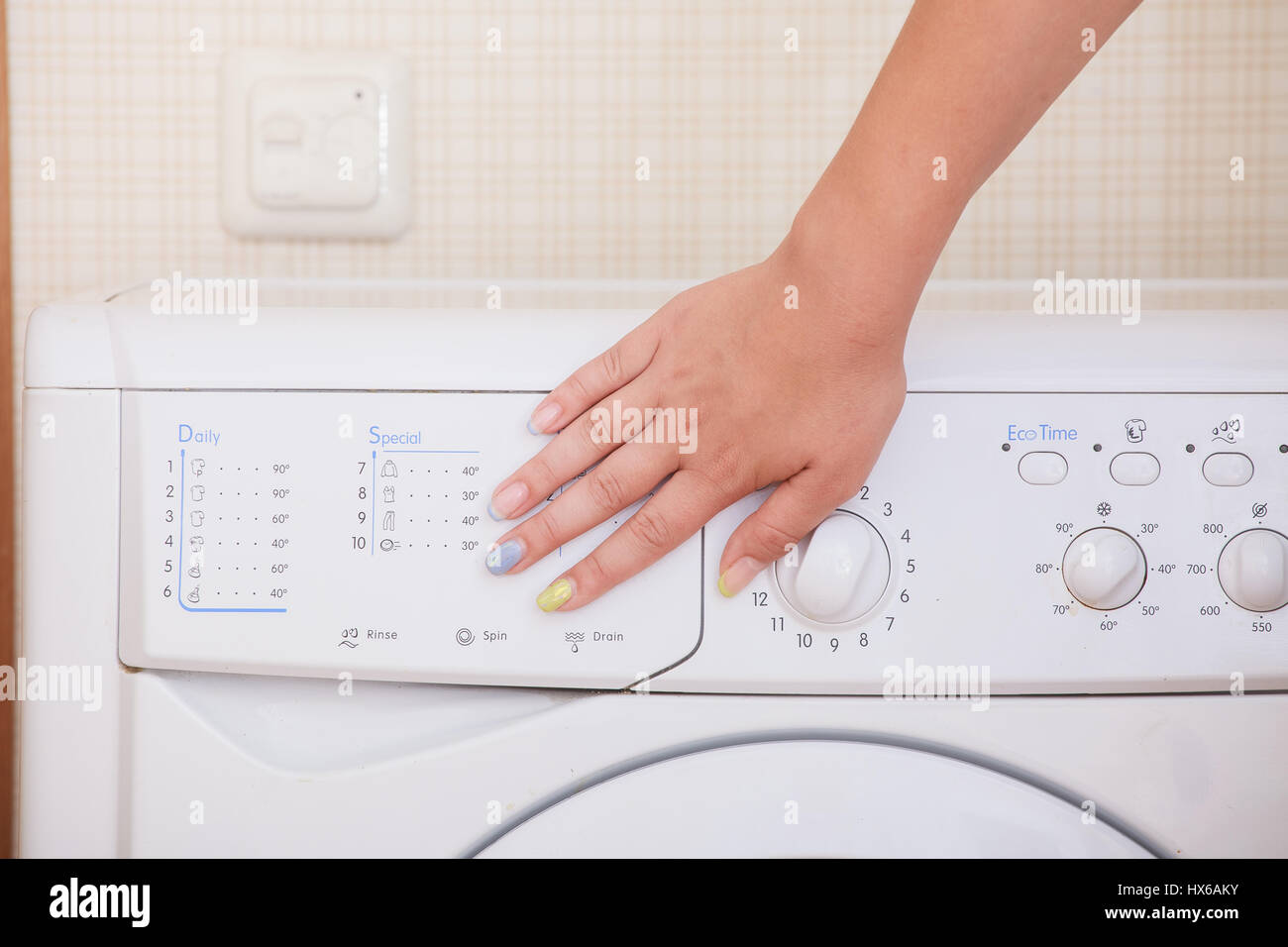 Close up of girl's hand adjusting washing machine Stock Photo - Alamy