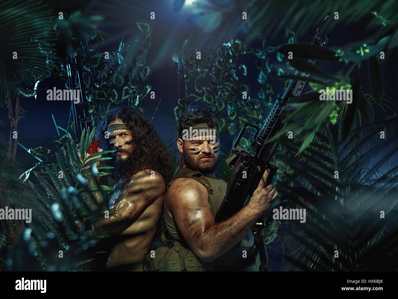 Two strong soldiers fighting in the rain forest Stock Photo - Alamy