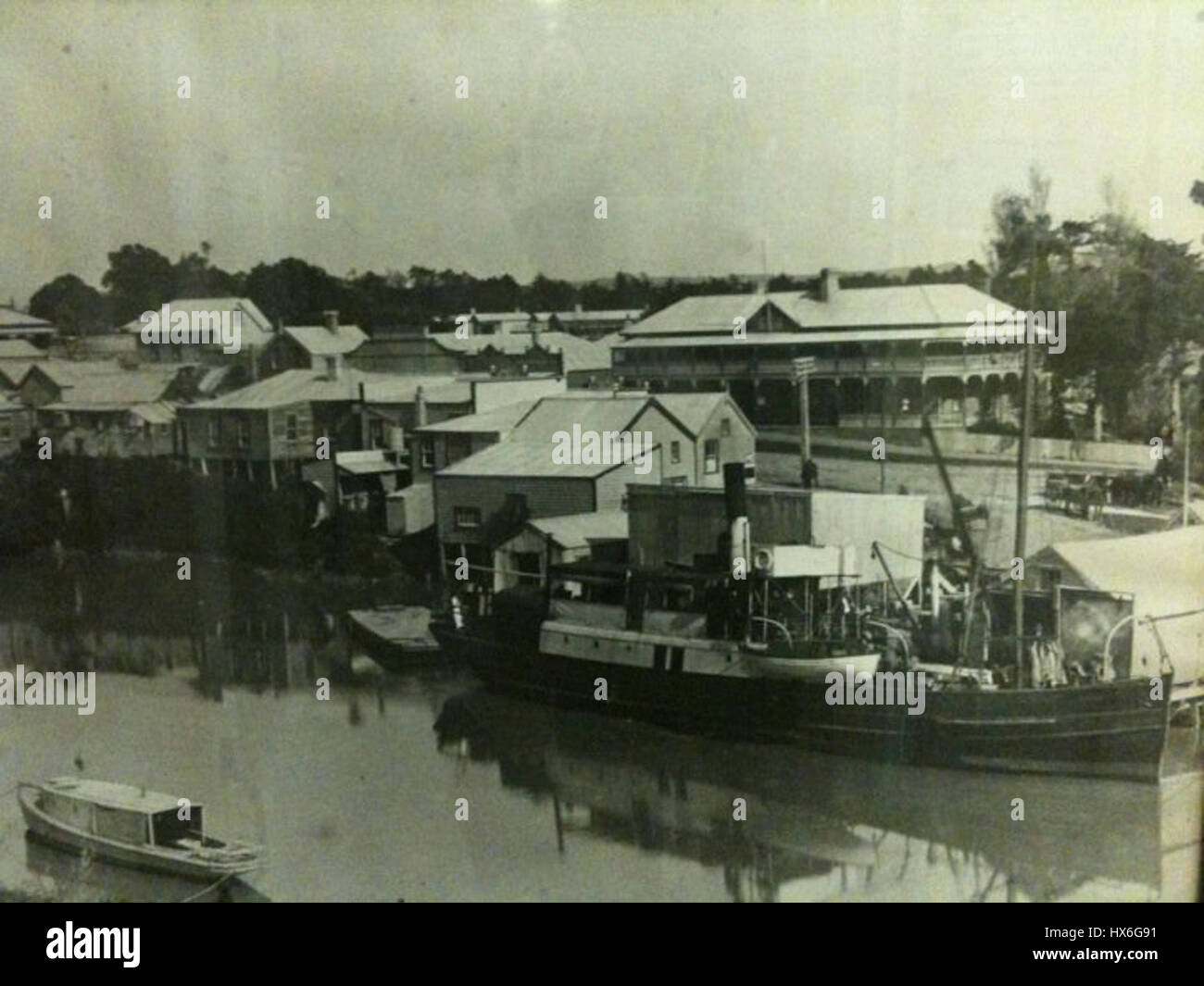 The painting 'Waiuku Harbor 1954' depicts a tranquil coastal scene of ...
