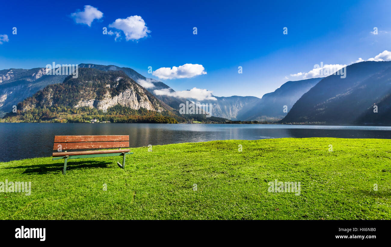 Wooden bench near the lake between by mountains Stock Photo - Alamy
