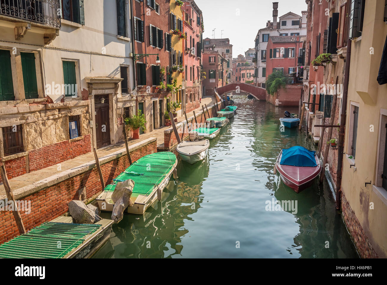 Boats and motorboats on a canal in Venice Stock Photo - Alamy