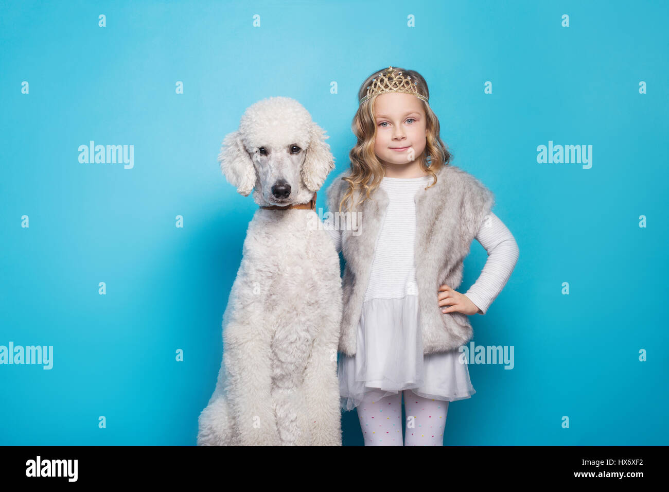 Beautiful little princess with dog. Friendship. Pets. Studio portrait ...