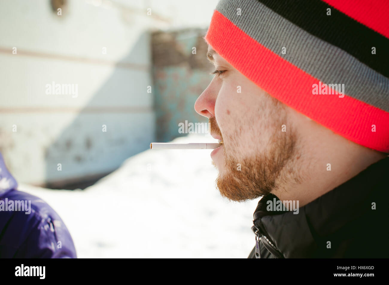 Portrait of a man with a beard with a mustache, smoking a cigarette ...