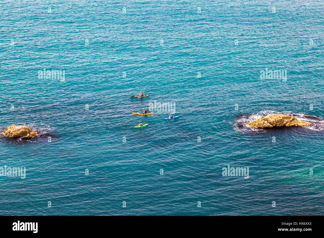 Looking down into Man O'War Bay at a group of sea kayakers negotiating ...