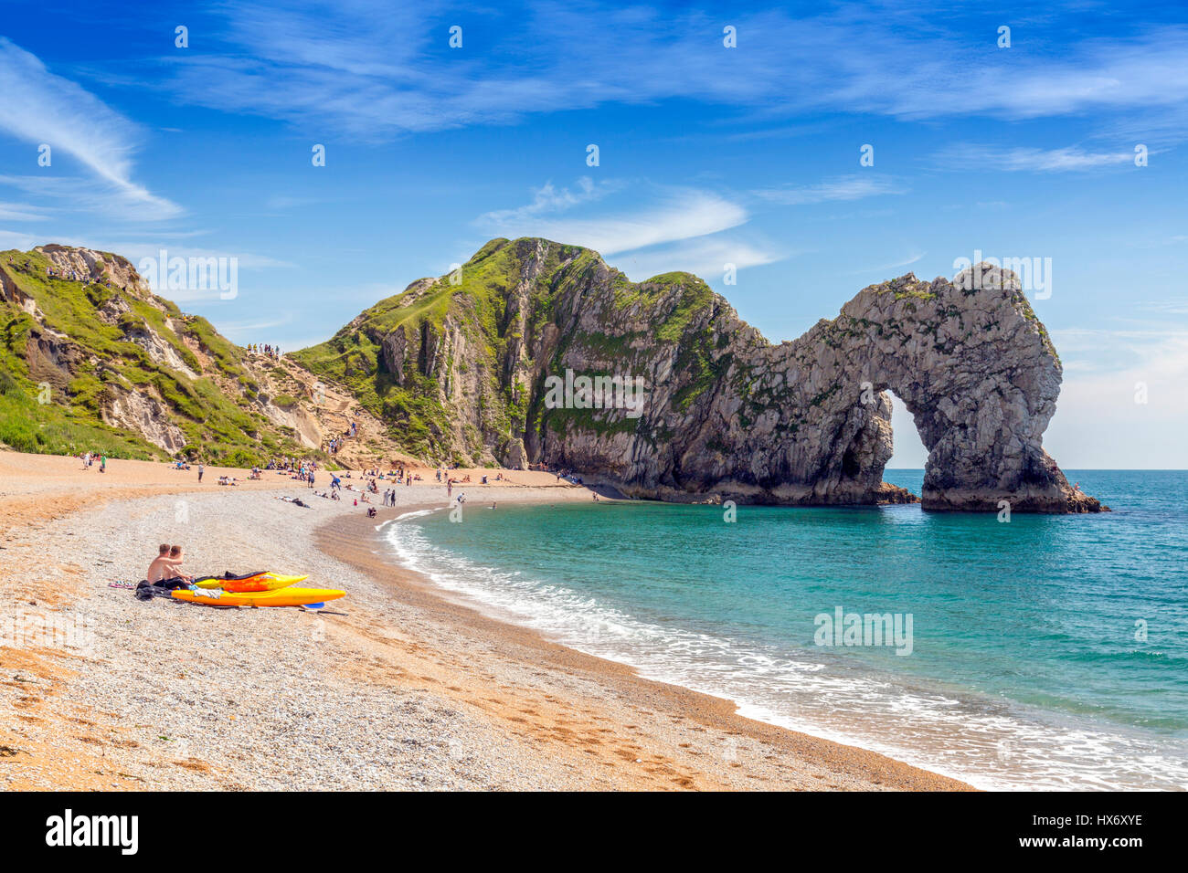 The natural limestone arch known as Durdle Door being admired by two ...