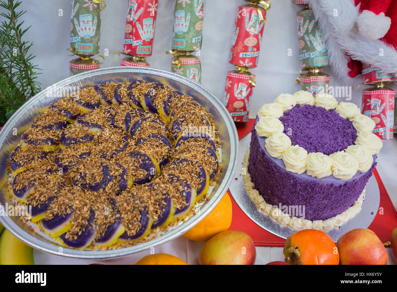 Filipino purple yam cake and sweets displayed with fruits at Christmas ...