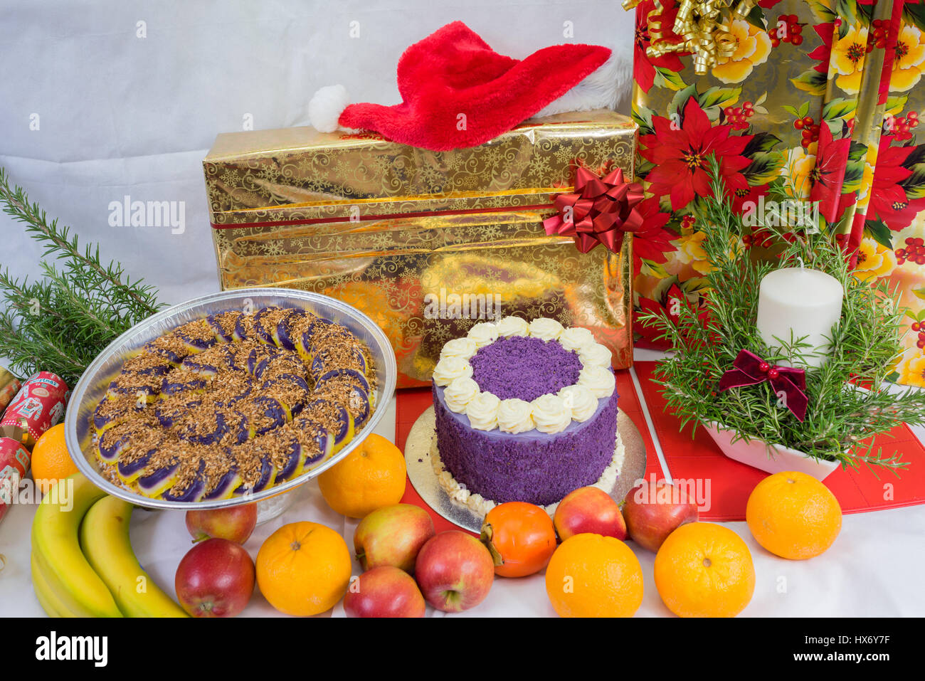 Filipino purple yam cake and sweets displayed with fruits at Christmas ...