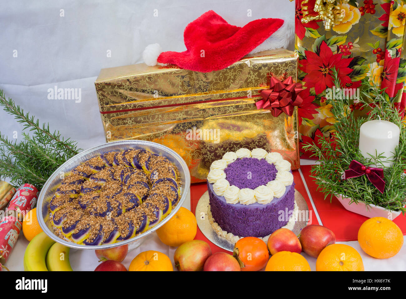 Filipino purple yam cake and sweets displayed with fruits at Christmas ...