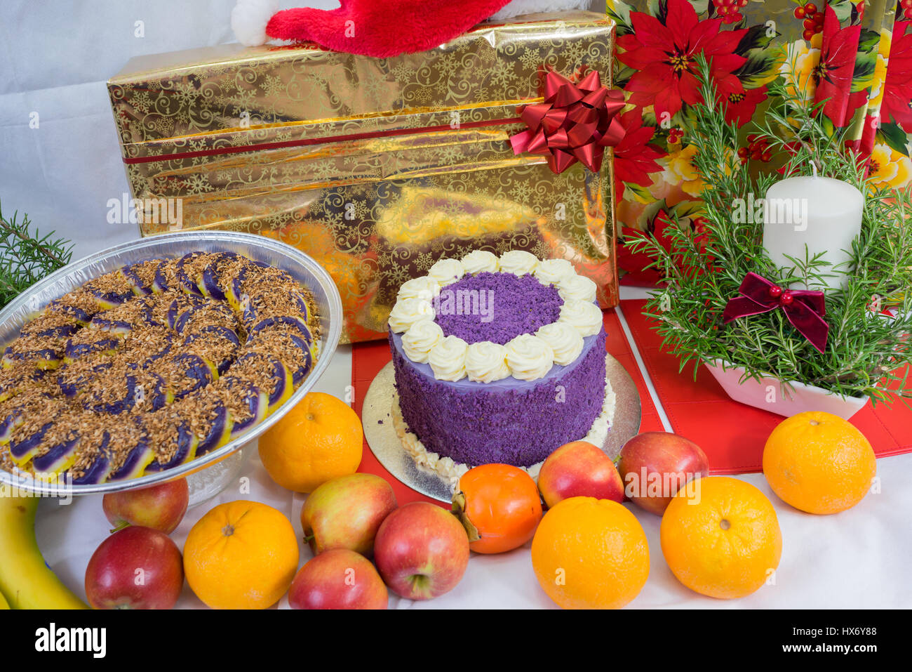 Filipino purple yam cake and sweets displayed with fruits at Christmas ...