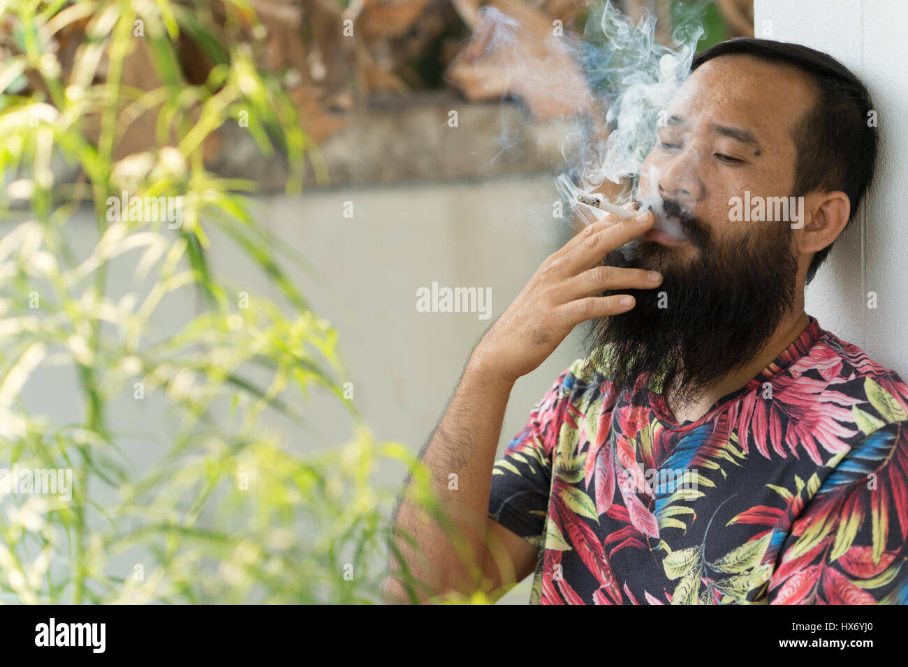 Portrait of adult man who is smoking cigarette Stock Photo - Alamy