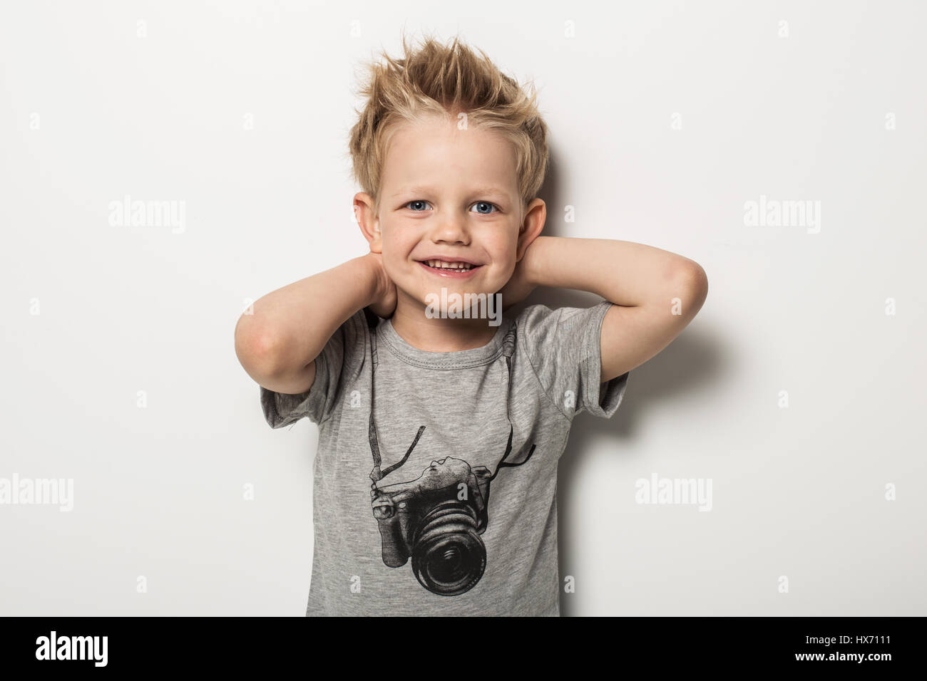 Little pretty boy posing at studio as a fashion model. Studio portrait ...
